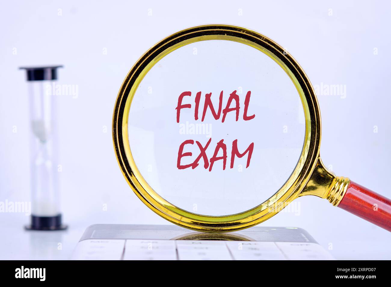 FINAL EXAM written through a magnifying glass on a uniform light ...