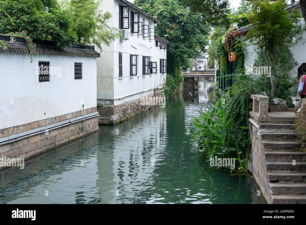Suzhou, China - June 11, 2024 : A narrow canal flows through a ...