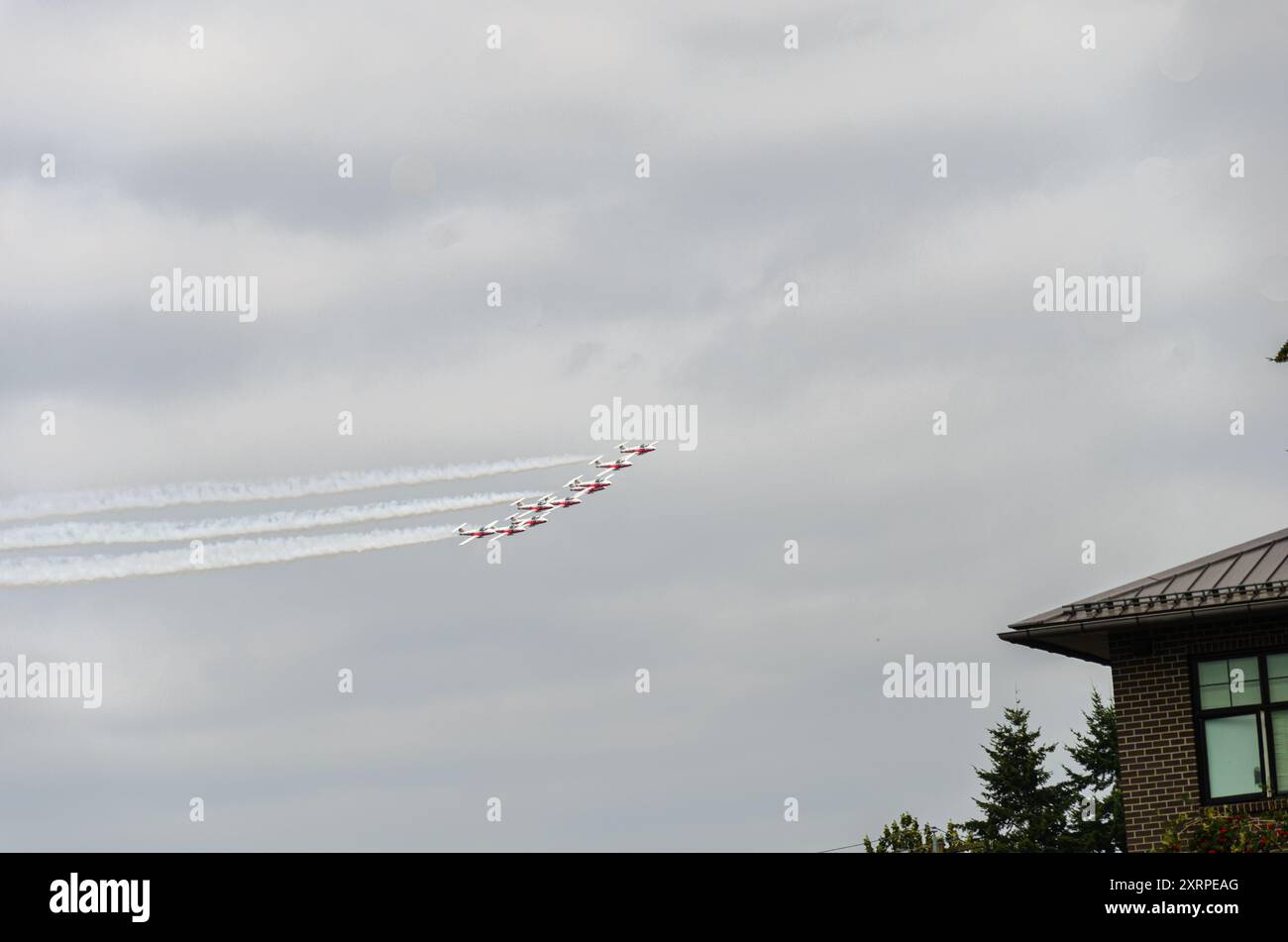A formation of nine aircrafts performing display and aerobatics during ...