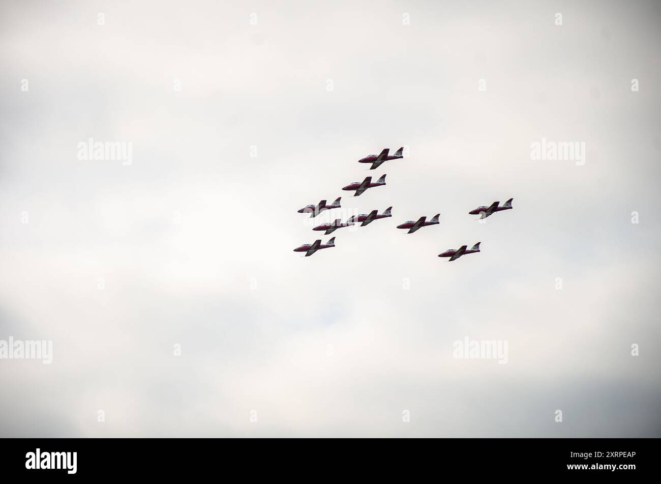 A formation of nine aircrafts performing display and aerobatics during ...