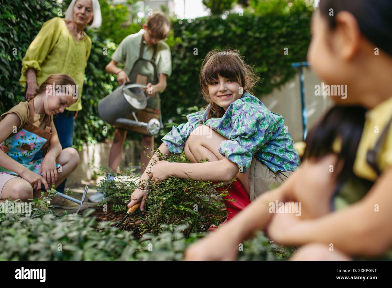 Students and female teacher at outdoor sustainable education class ...