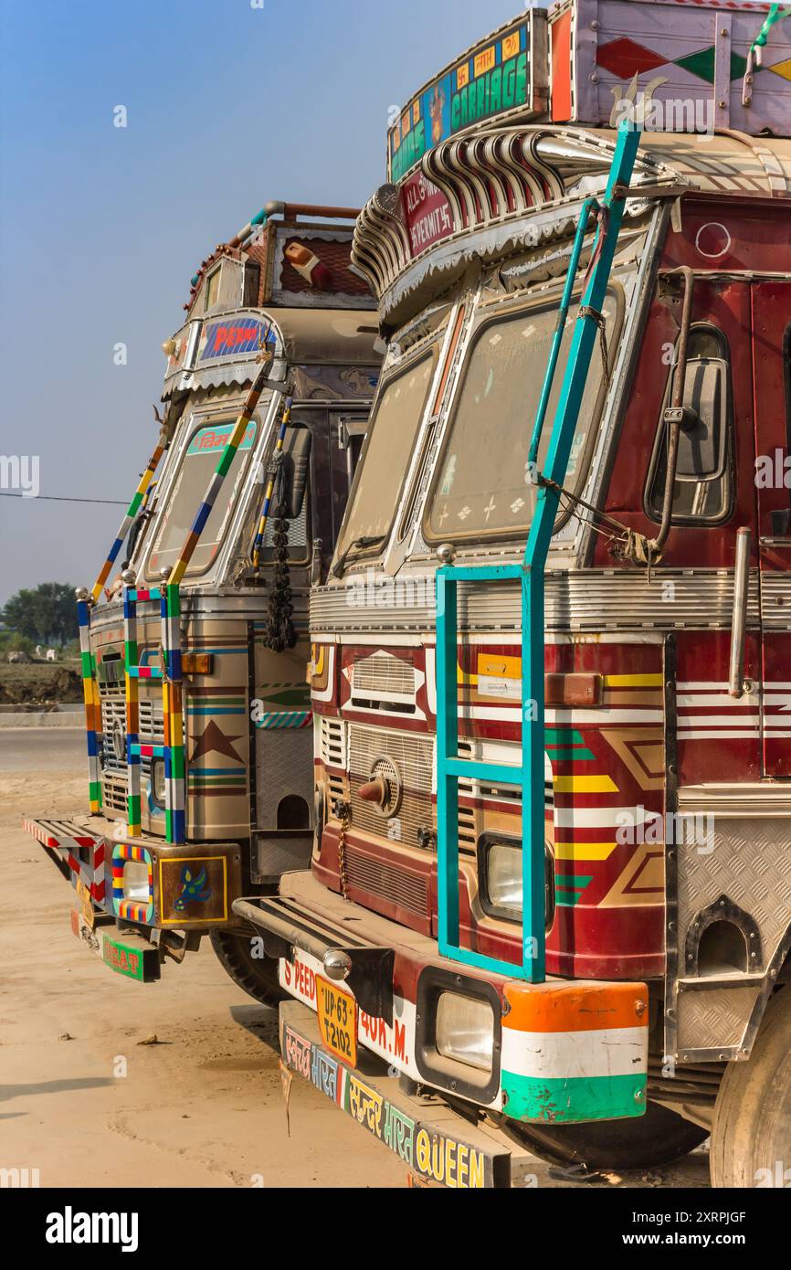 Two colorful indian trucks with ladders on the front Stock Photo - Alamy
