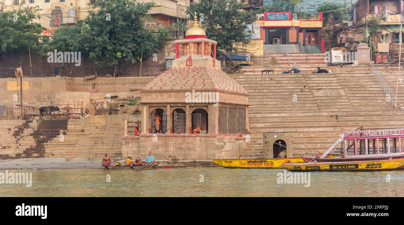Panorama of a temple and boats at the Scindia Ghat in Varanasi, India ...