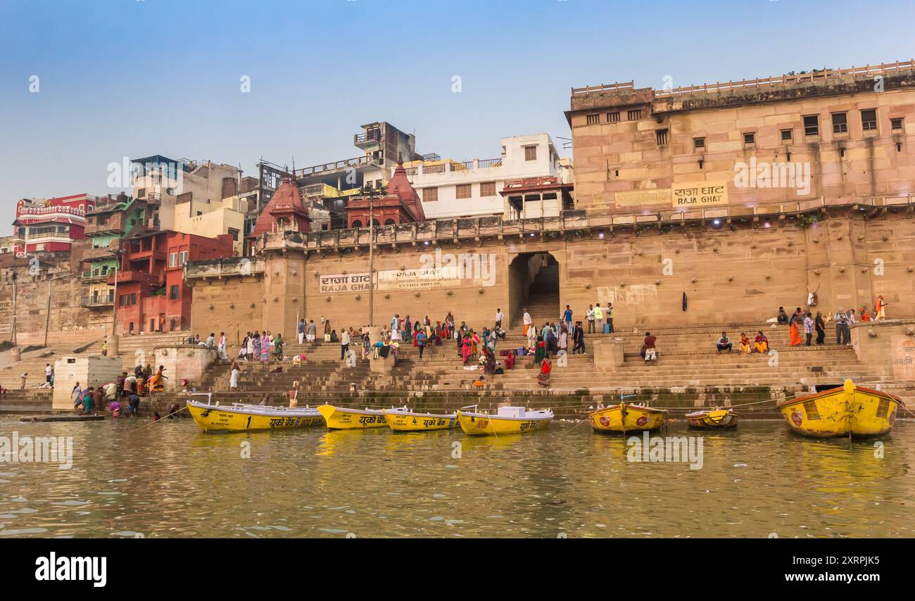 Panorama of boats and historic buildings at the Raja Ghat in Varanasi ...