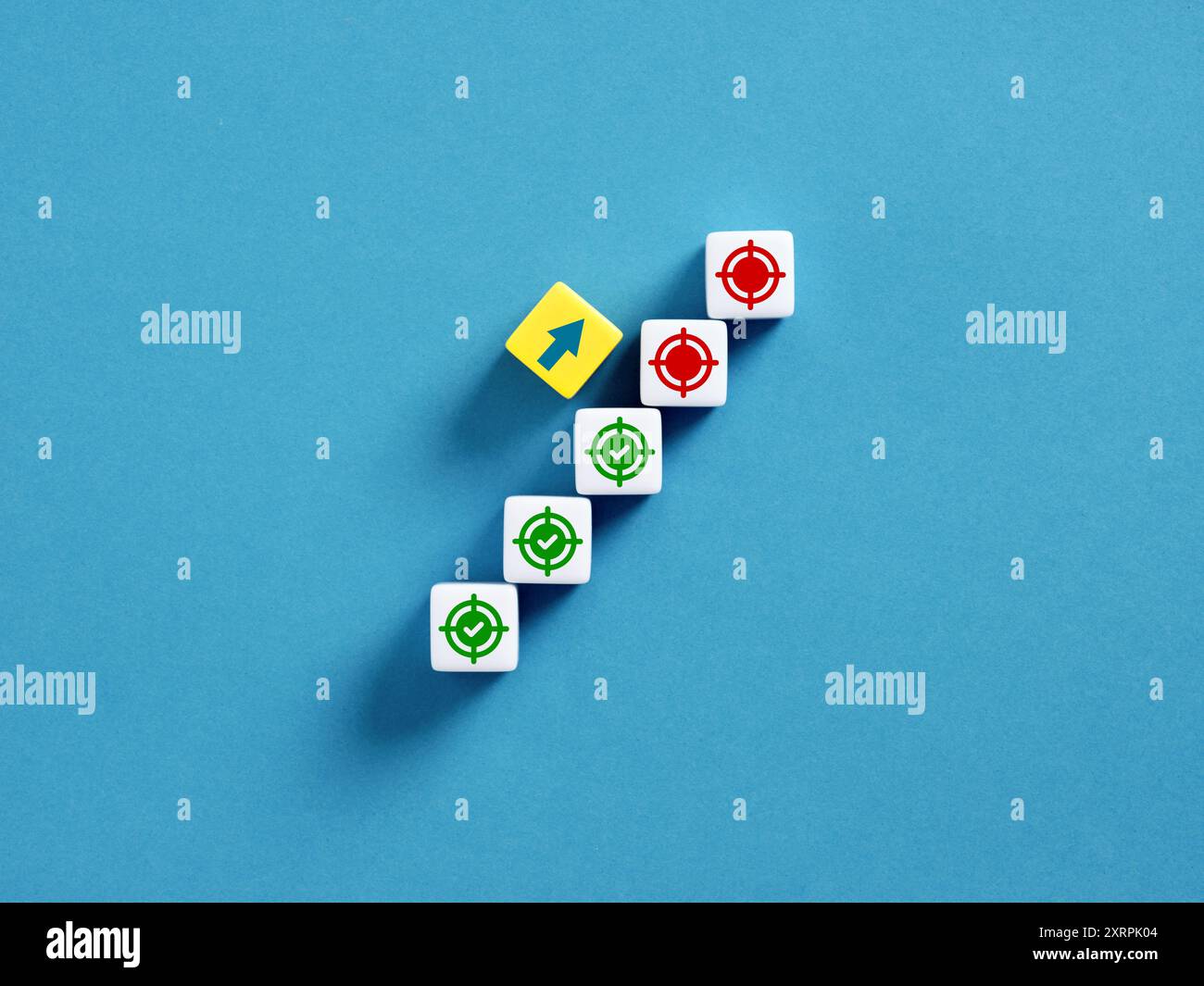 Row of cubes illustrating the concept of achieving business goals, with ...