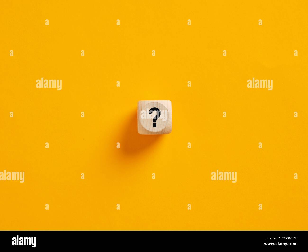 Problem, query, solution, confusion or counseling concepts. Single wooden cube on a yellow ...