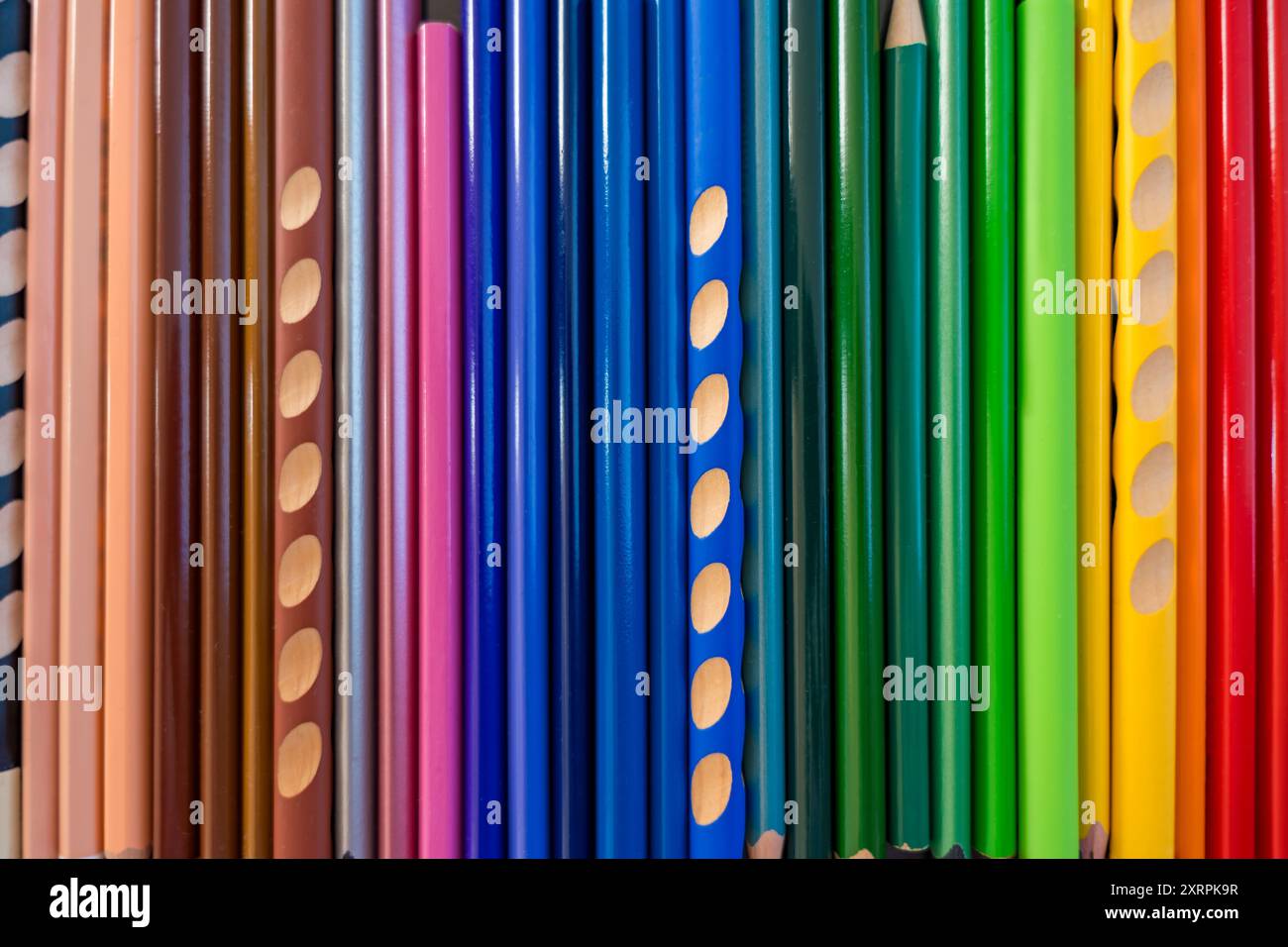 Vibrant colored pencils perfectly aligned for a creative challenge ...