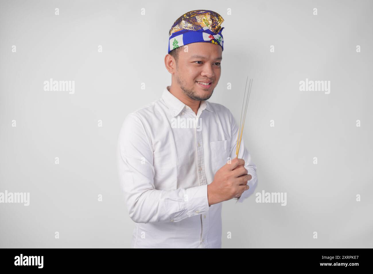 Balinese man wearing traditional headdress called udeng doing paying ...