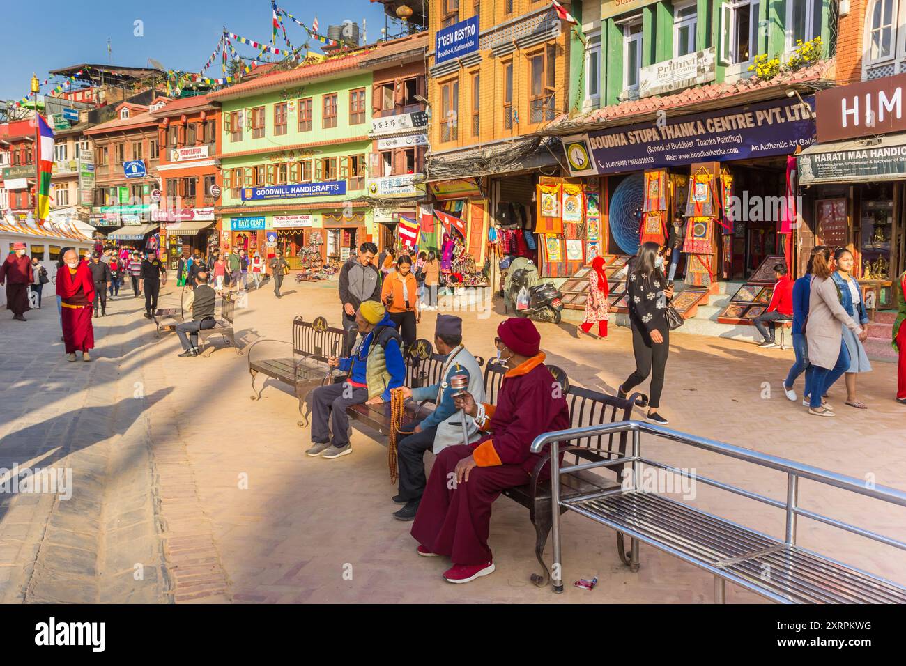 Nepalese men sitting on a bench at the Boudhanath stupa in Kathmandu ...