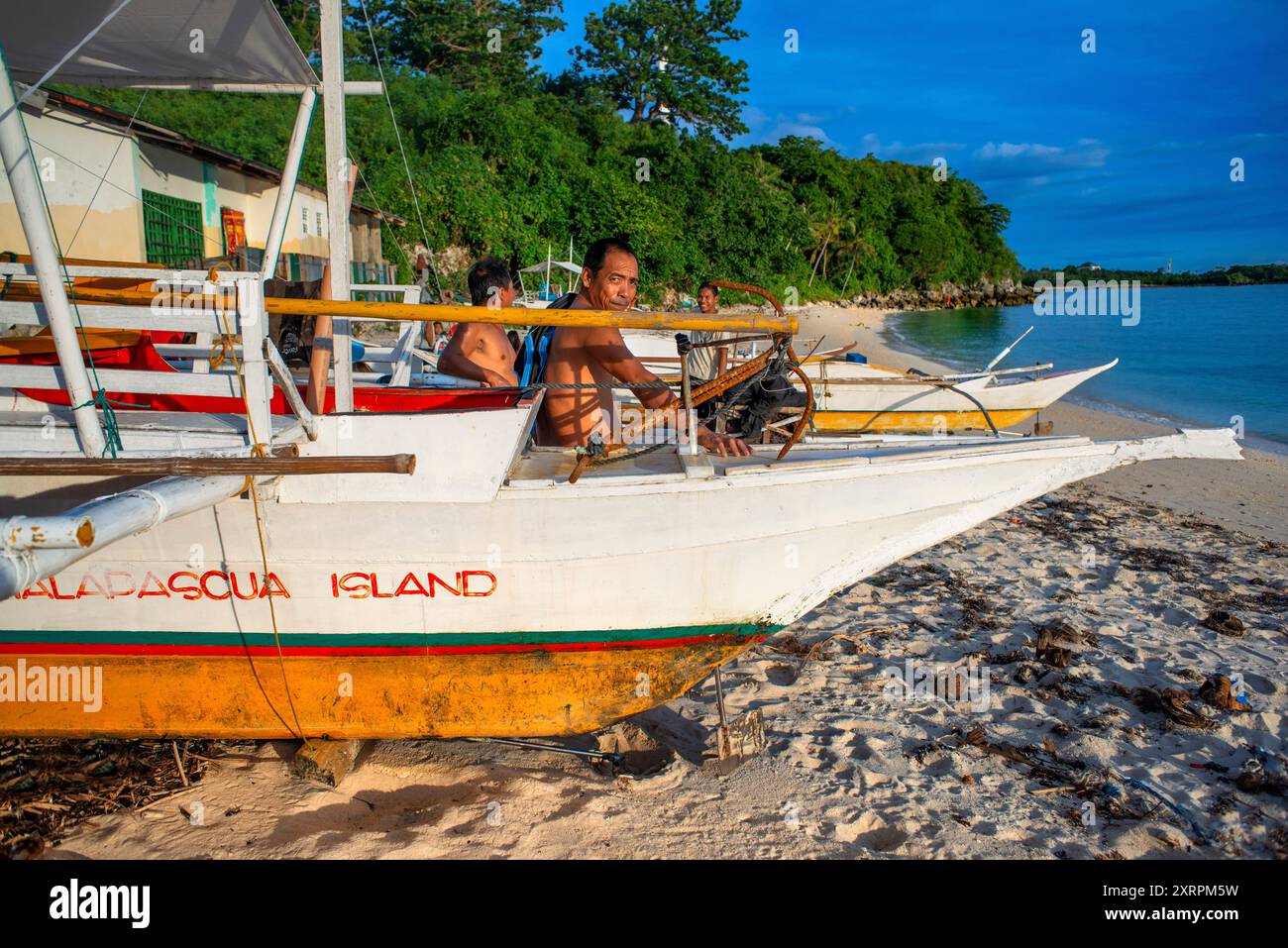 Local fishers in Guimbitayan beach next to white sand beach in Malapascua island, Cebu ...