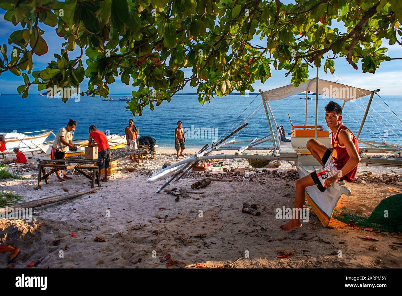 Local fishers in Guimbitayan beach next to white sand beach in Malapascua island, Cebu ...