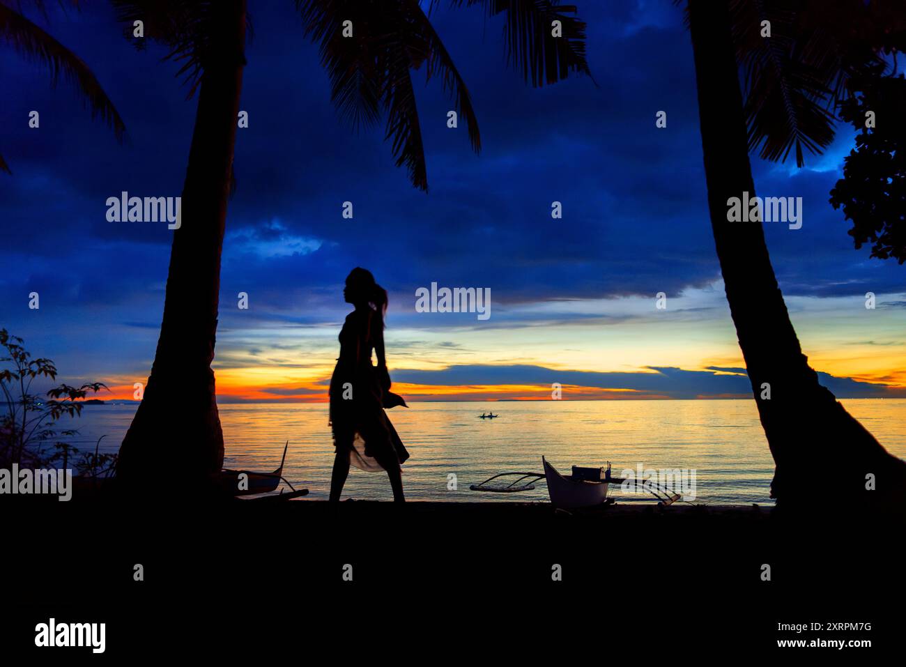 Local woman in the sunset in the beach white sand Langub beach in Malapascua island, Cebu ...