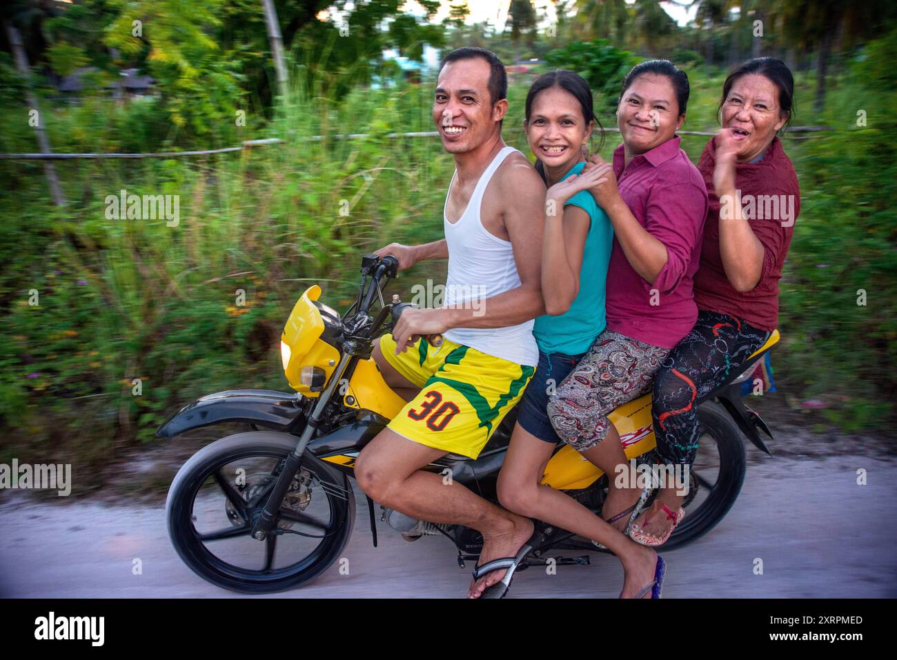 Local people, fanny many people driving a motorcyce in Sipaway Island ...