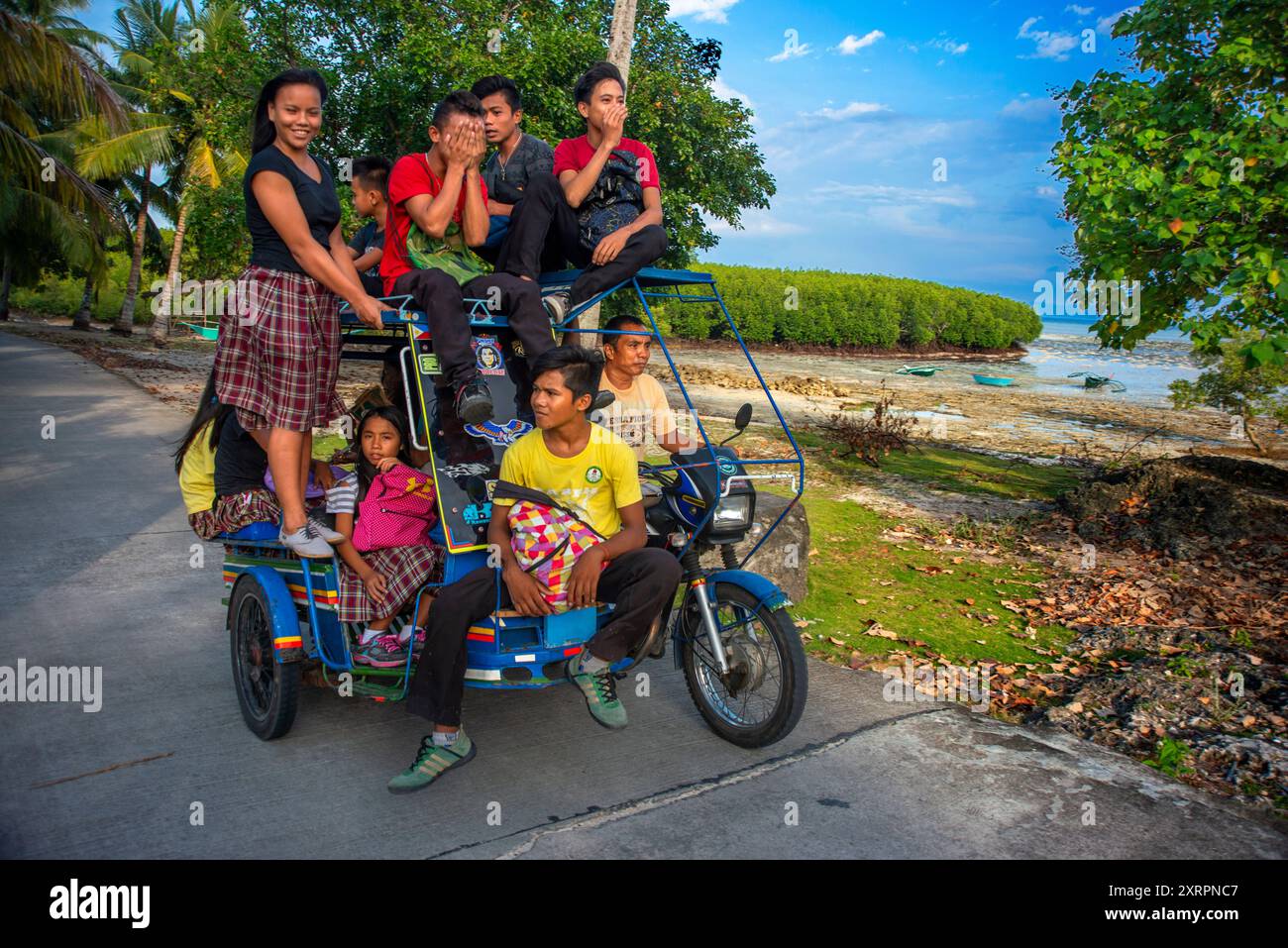 Local students, fanny many people driving a motorcyce in Sipaway Island ...