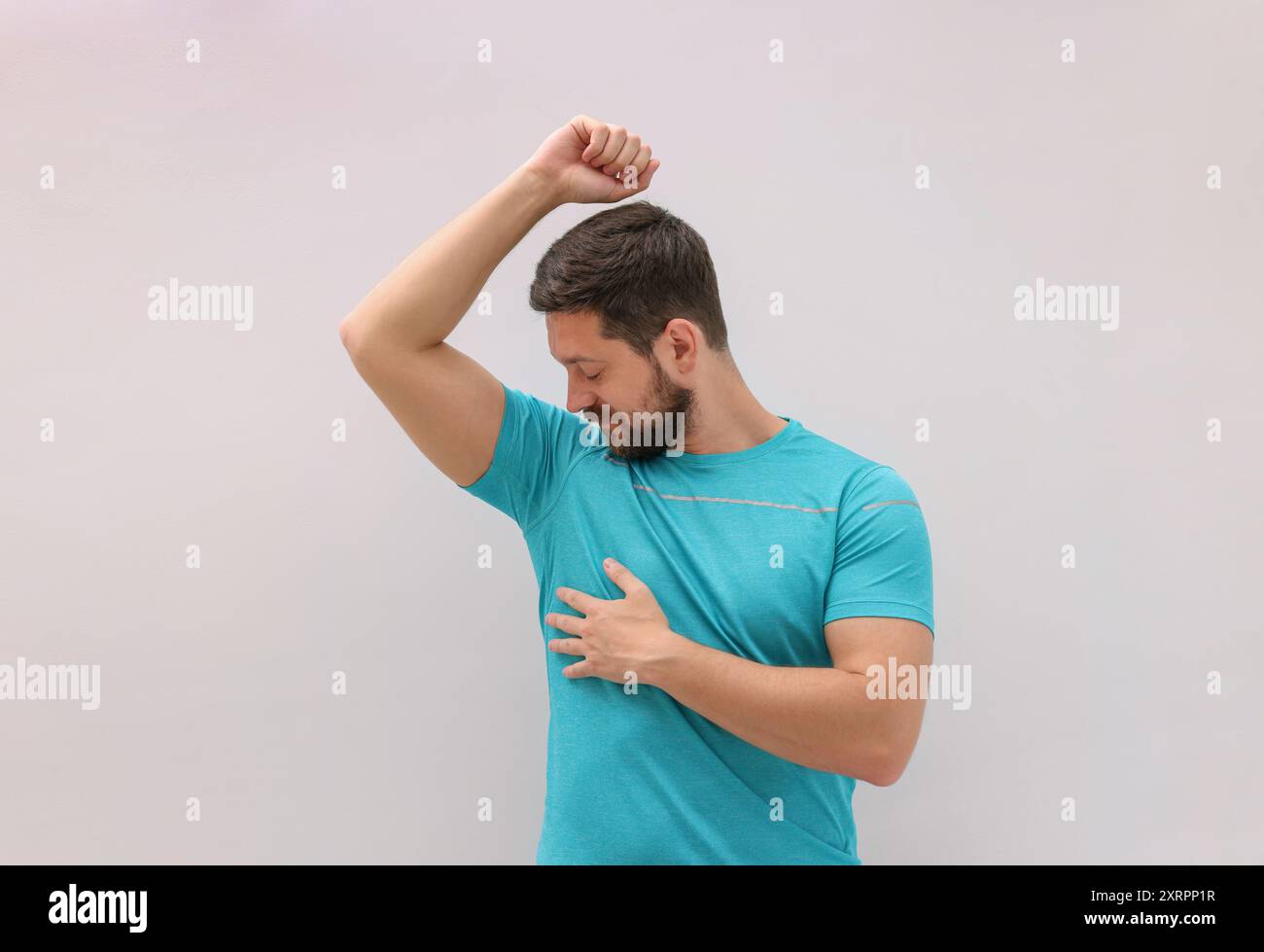 Handsome man after using deodorant on white background Stock Photo - Alamy