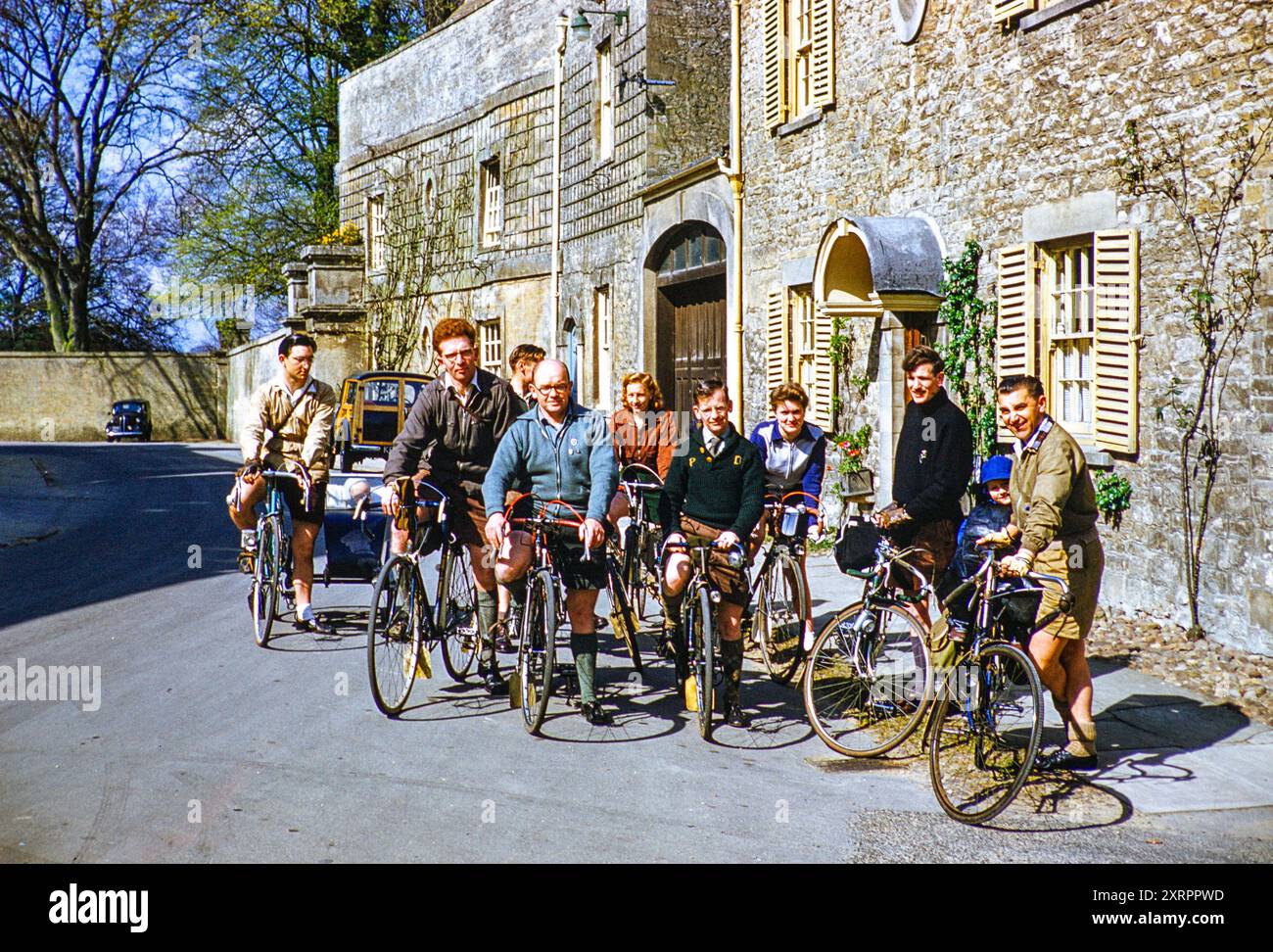 Group portrait of cycling club cyclists holding their bikes outside ...