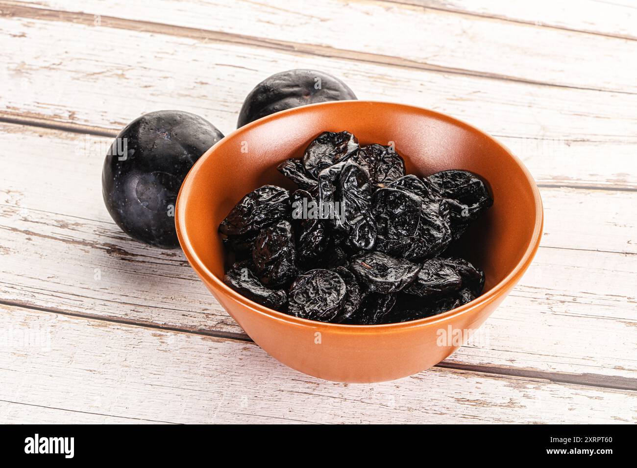 Dry sweet prunes in thw bowl Stock Photo - Alamy