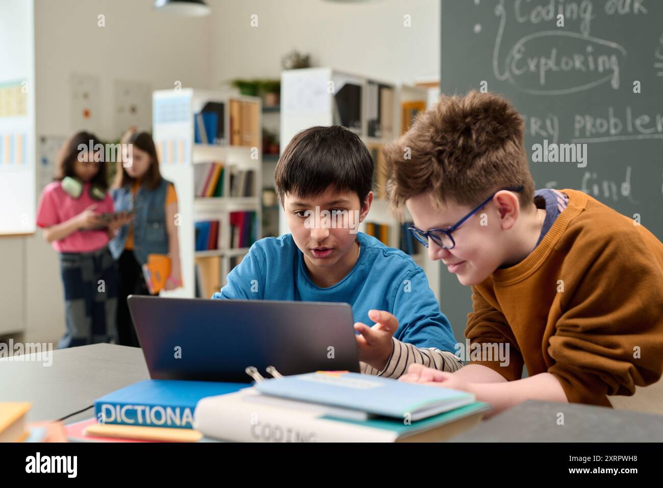Two Boys using Computer in School Library Stock Photo - Alamy