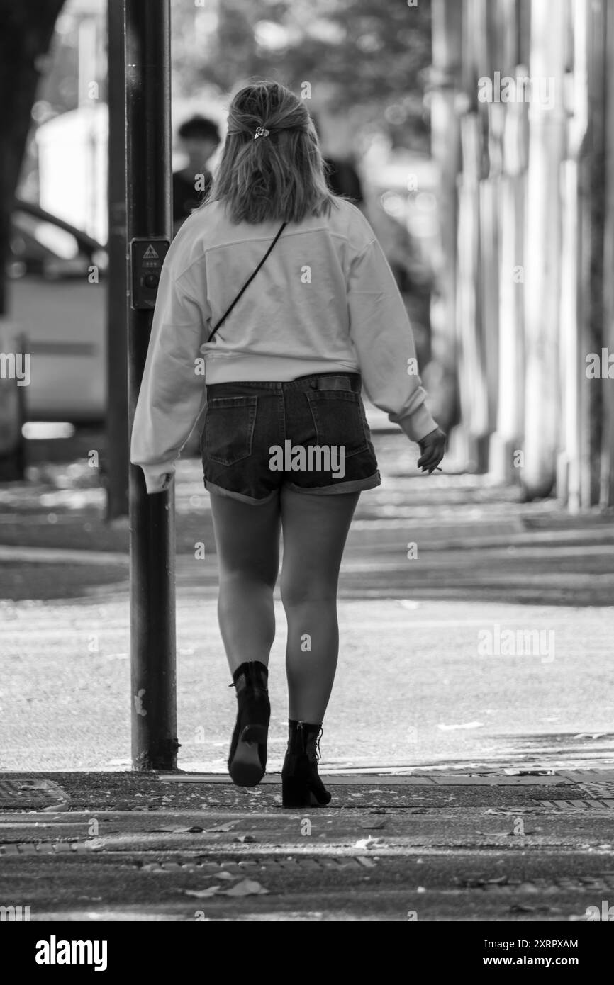 Woman walking on the street. Real people. Black and white Stock Photo ...