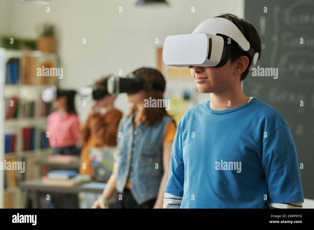 Smiling Boy Wearing VR with Group of Children Stock Photo - Alamy