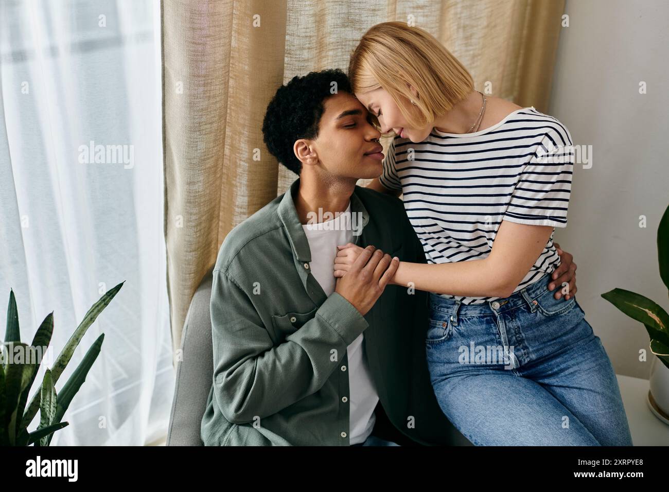 Young couple sits close hi-res stock photography and images - Alamy
