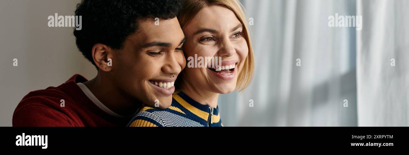 A happy multicultural couple shares a loving moment in their modern ...