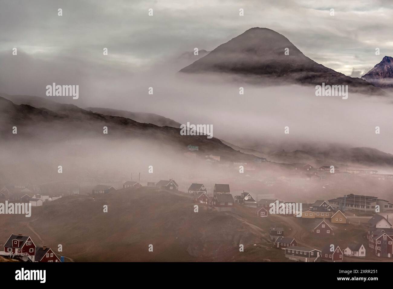 Remote Inuit settlement in mountain scenery, foggy, cloudy, Tasiilaq ...