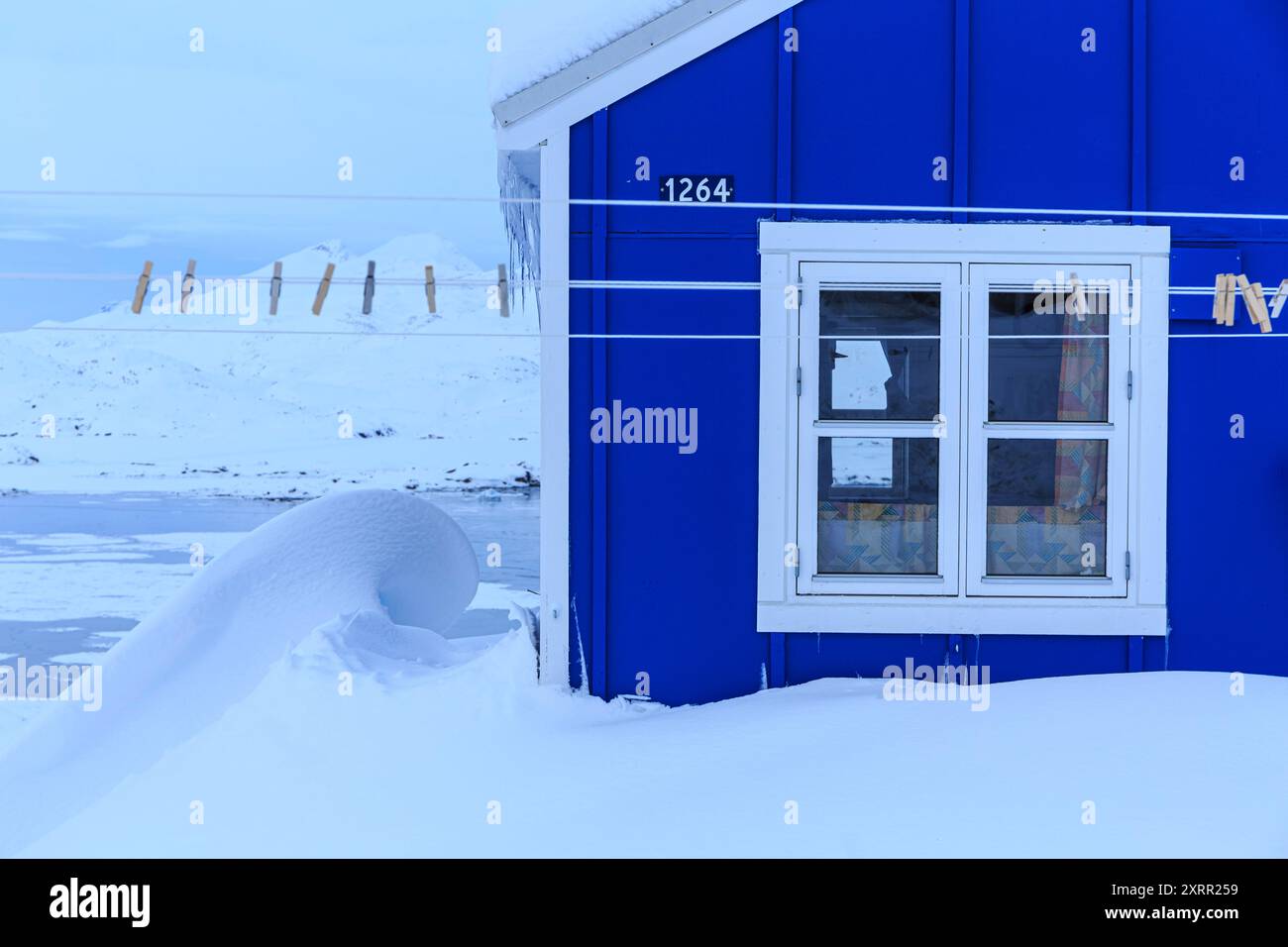 Snow covered typical greenlandic house in winter, deep snow, Tasiilaq ...