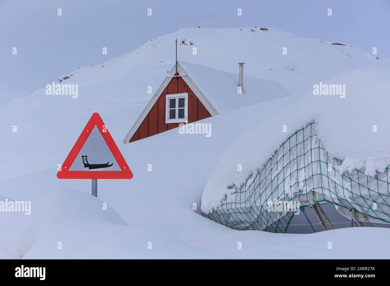 Warning sign for sleds in deep snow in an inuit village, Tasiilaq, East ...