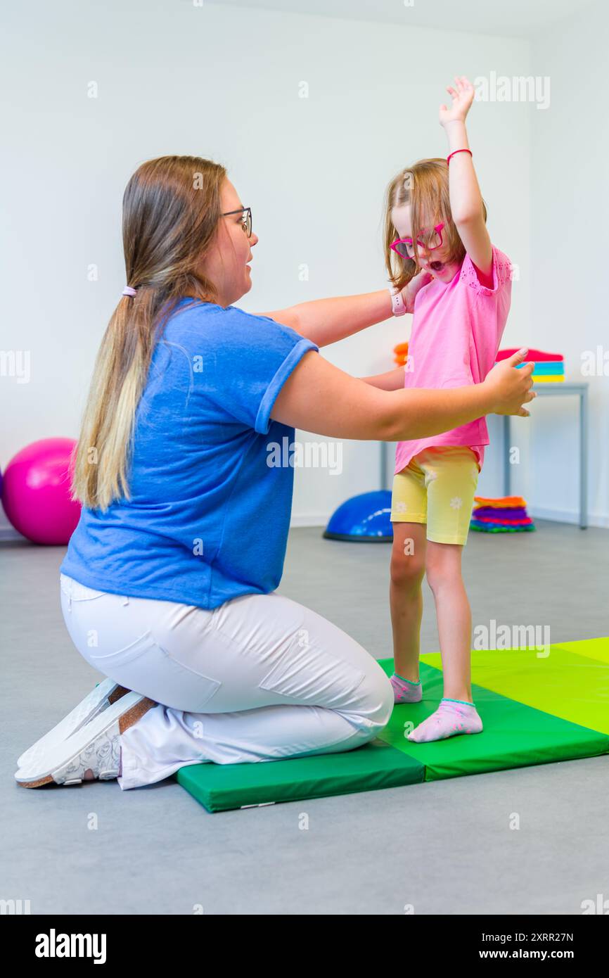 Child with physical disability in physical therapy session. Child ...