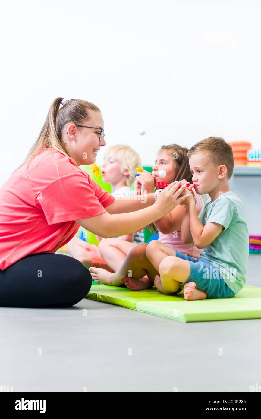Group of young children making breathing exercises during physical ...