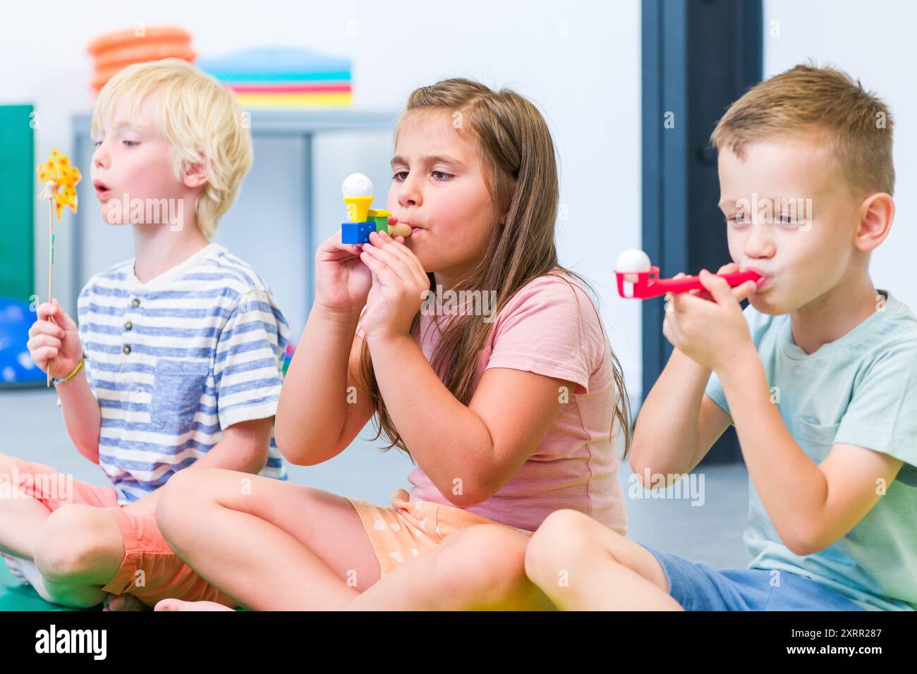 Group of young children making breathing exercises during physical ...