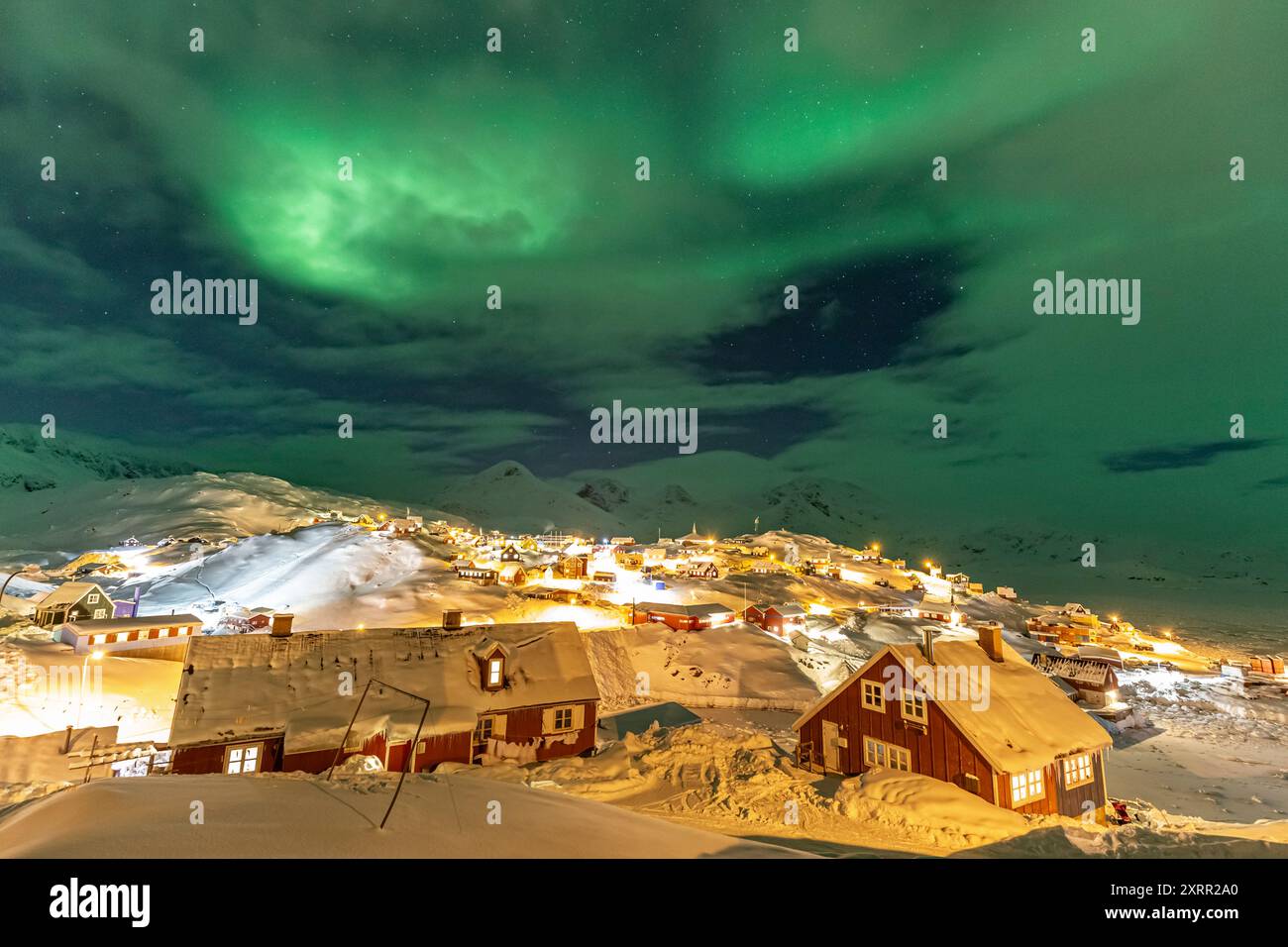 Green northern lights, aurora borealis over a typical greenlandic red ...
