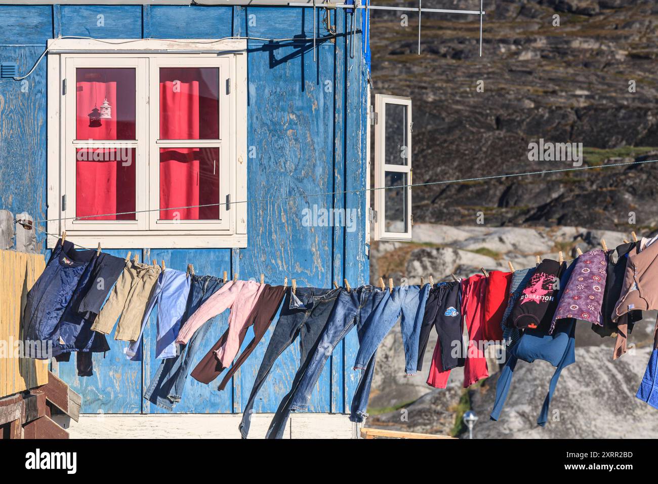 Clothes drying on a washing line in the wind in front of a house, inuit ...