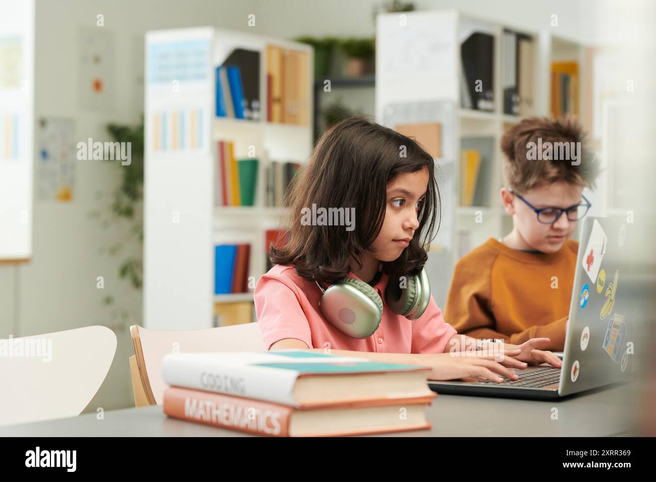 Girl using Computer in School Library Studying IT Stock Photo - Alamy