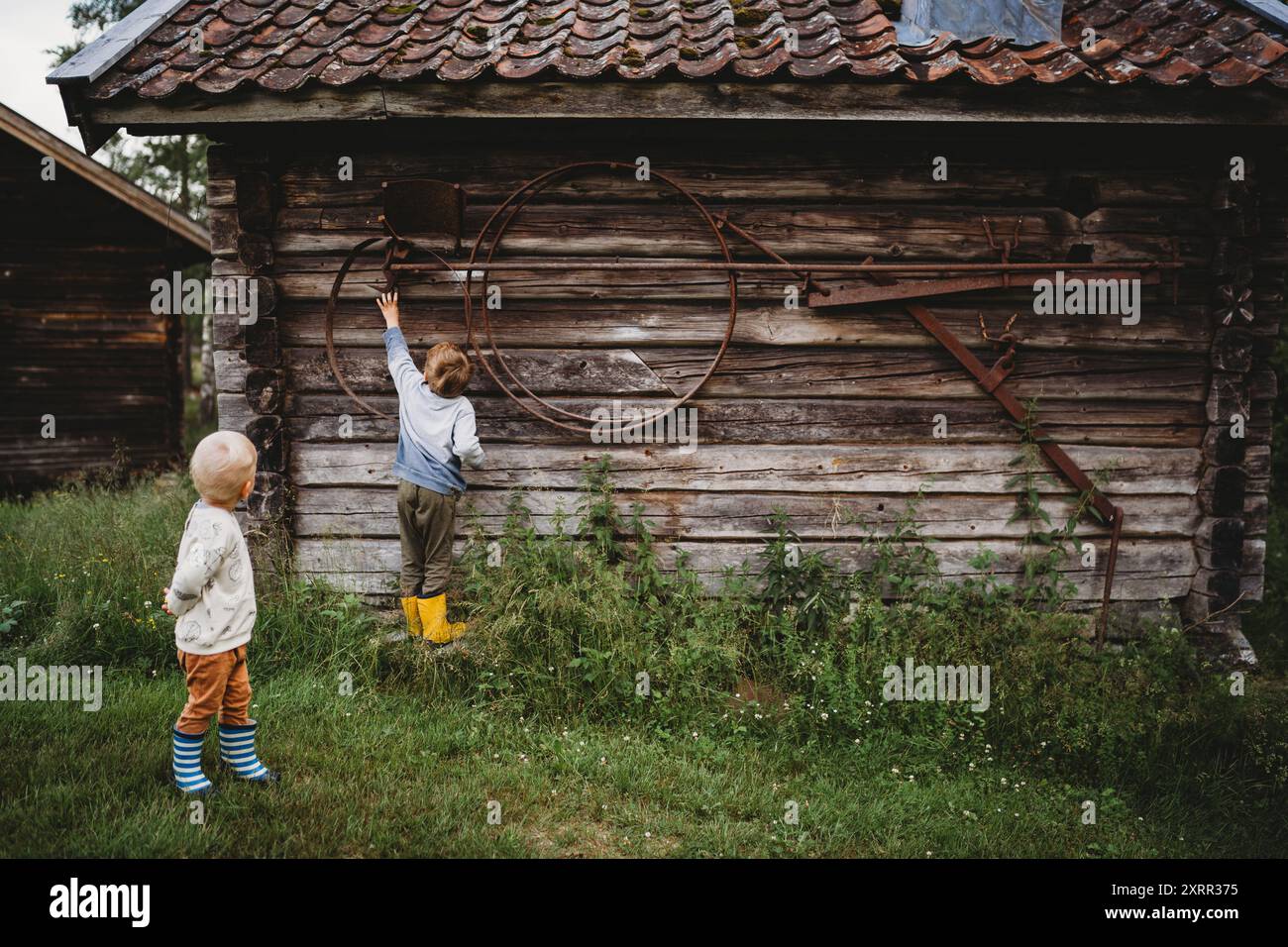 Young children exploring wooden cabin Scandinavian woods Stock Photo ...