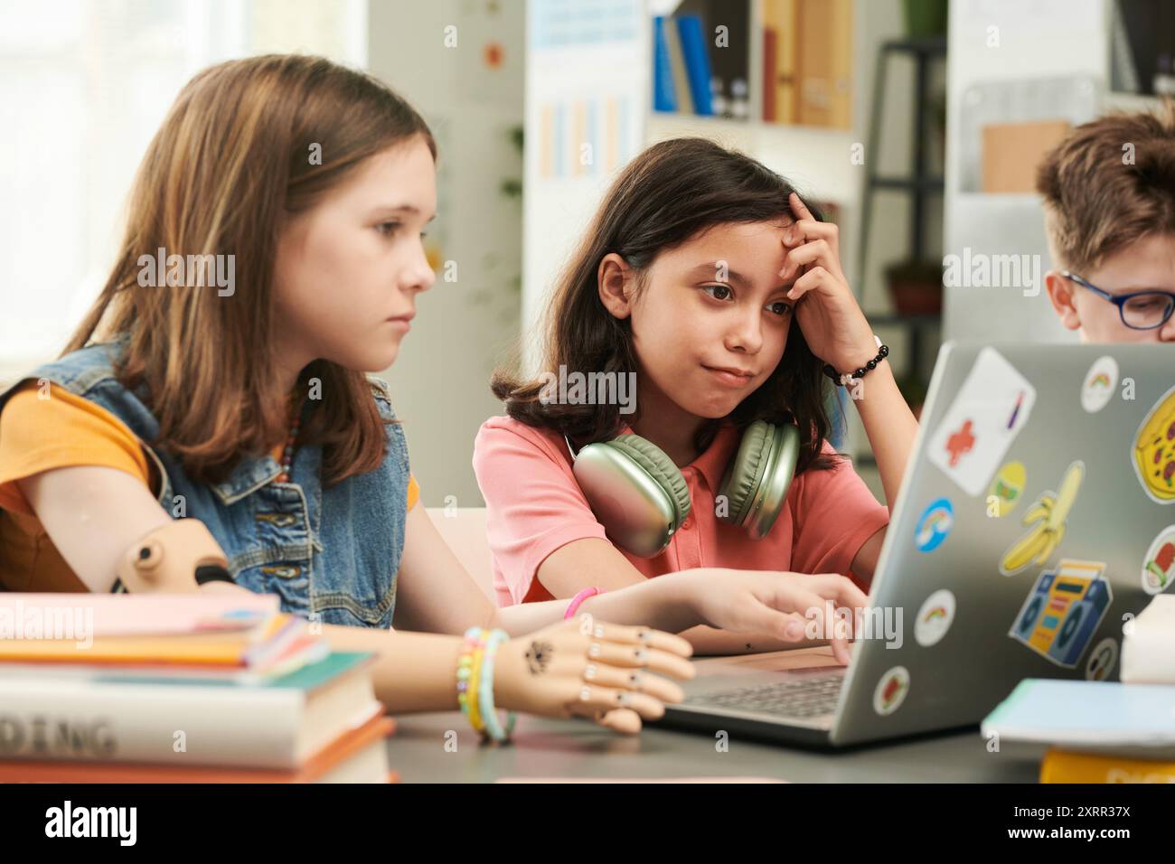 Two Girls using Computer in Library Stock Photo - Alamy