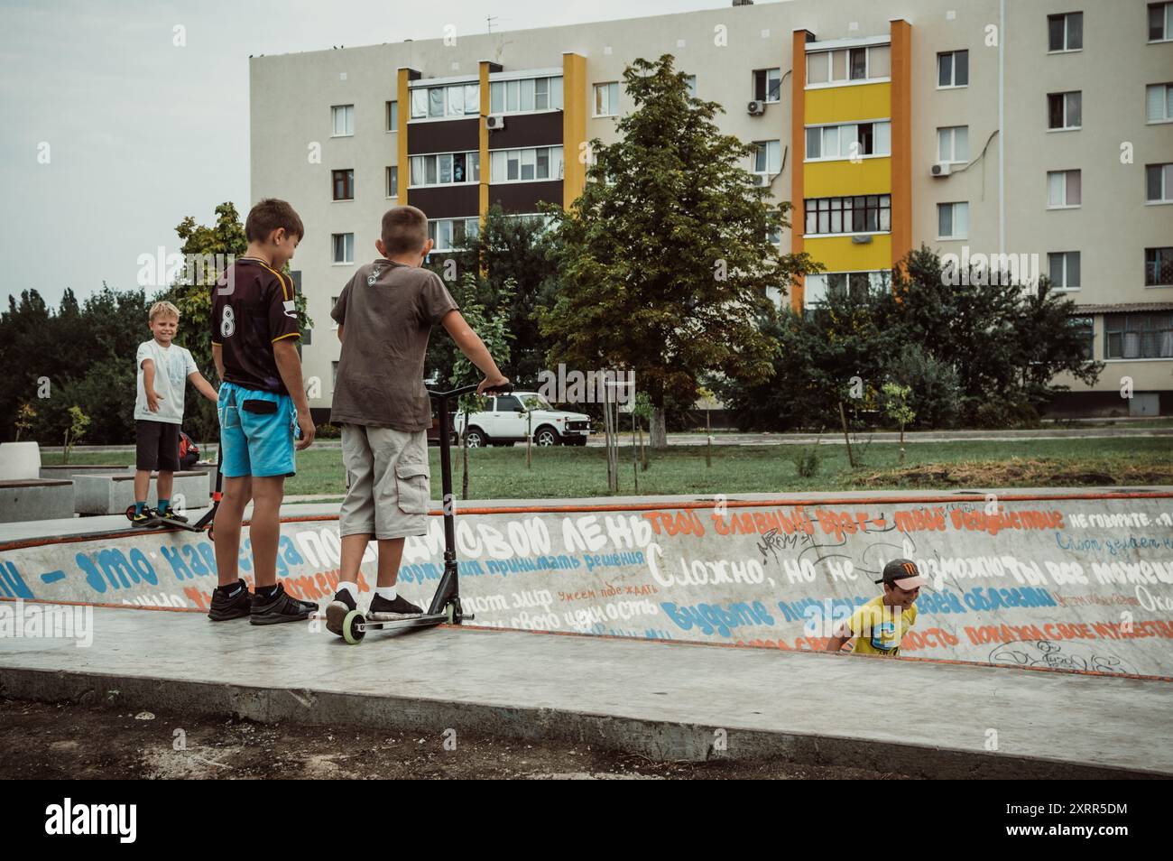 Boys on scooters hi-res stock photography and images - Alamy
