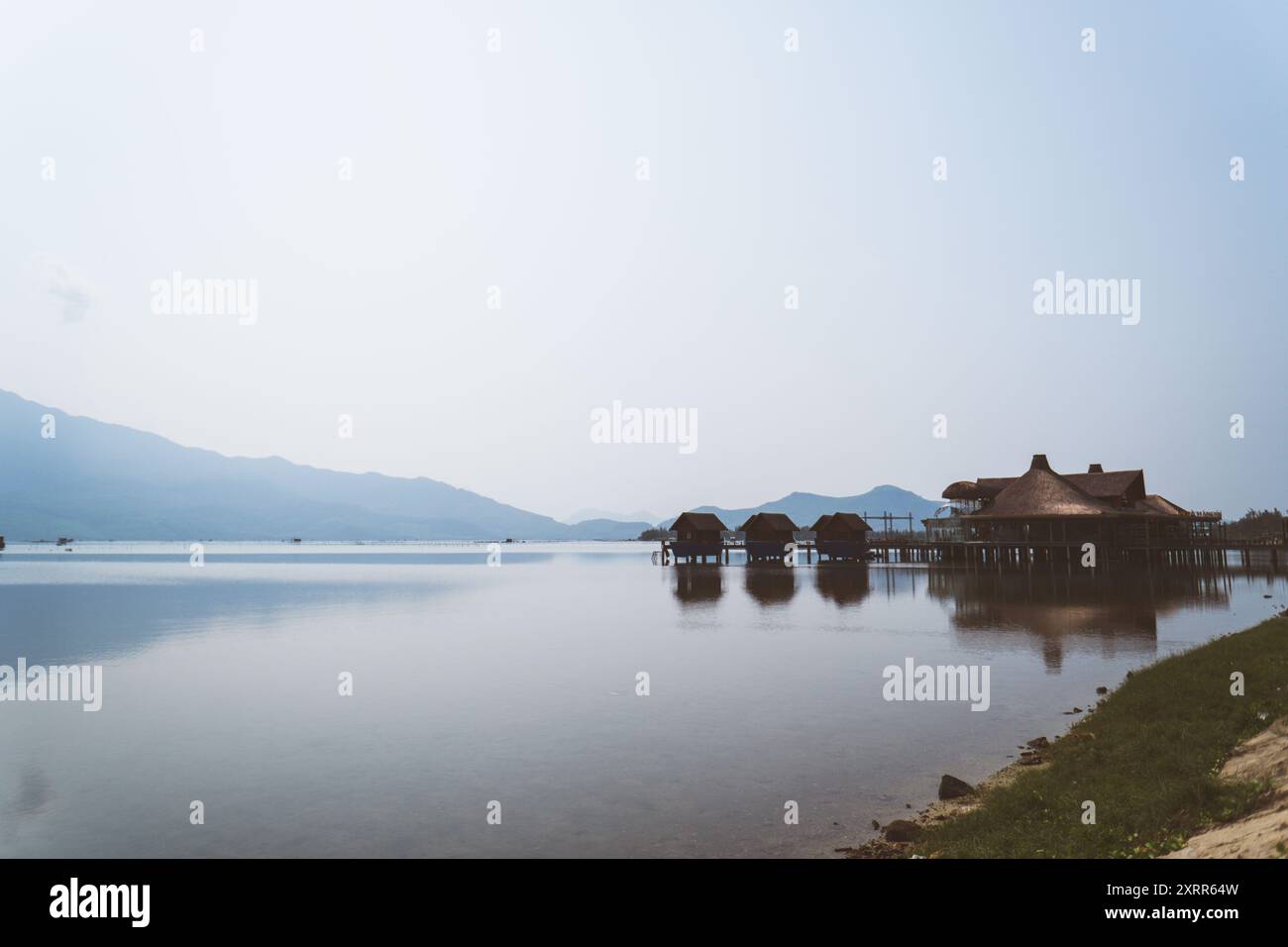 Tropical Huts over still water Stock Photo - Alamy