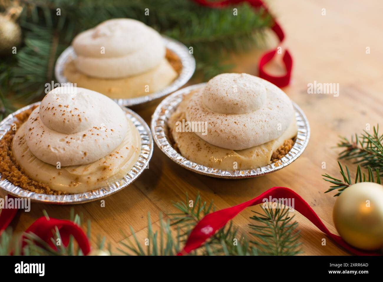 3 Mini egg nog cream pies dusted with nutmeg Stock Photo - Alamy
