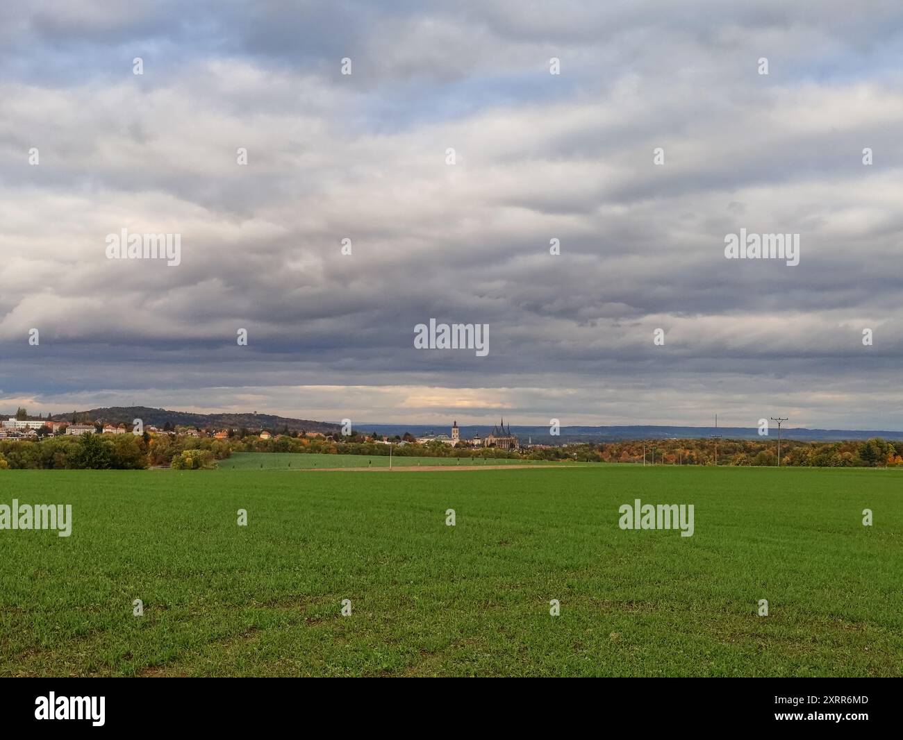 Green fields contrast with gray clouds above Kutna hora St. Barbaras ...