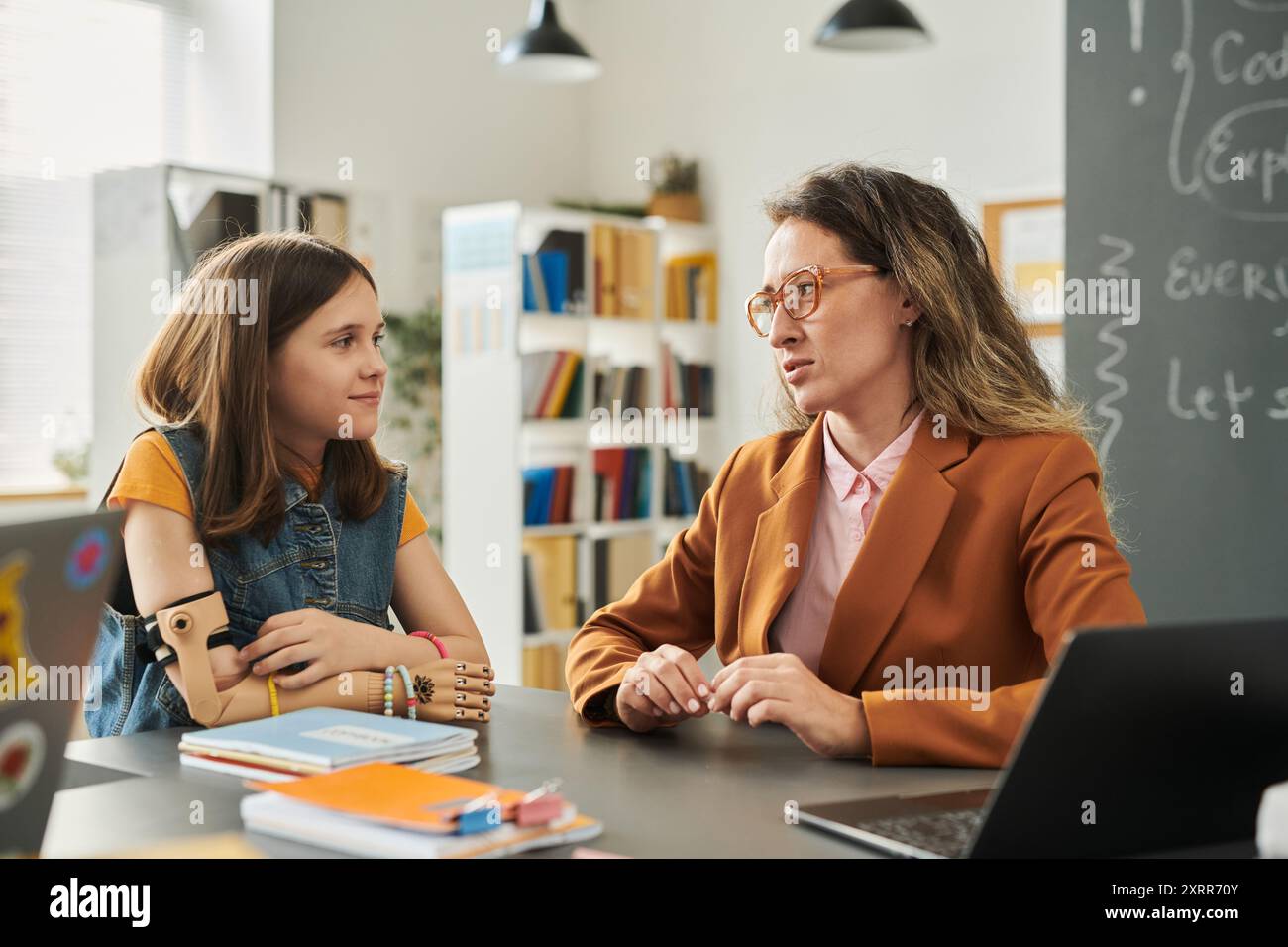 Caring Teacher Talking to Girl Stock Photo - Alamy