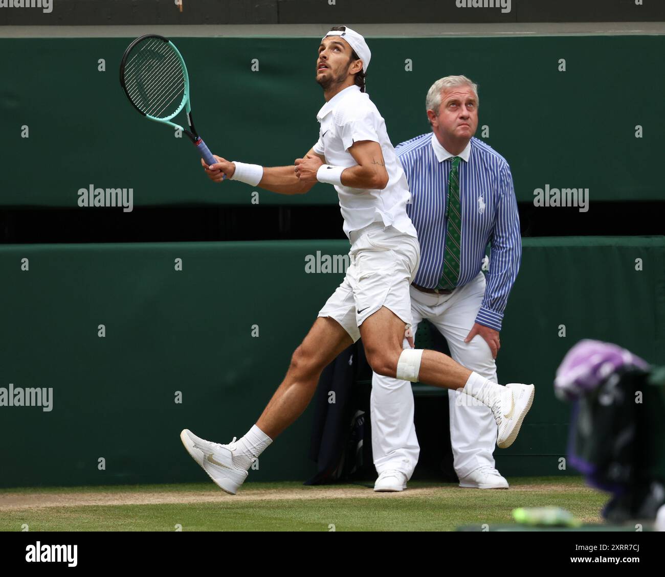 Italian tennis player Lorenzo Musetti in action at the 2024 Wimbledon ...
