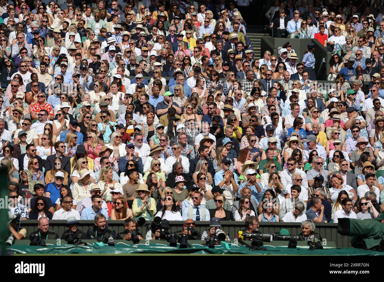 Spectators sitting in the sun on centre court at the 2024 Wimbledon ...