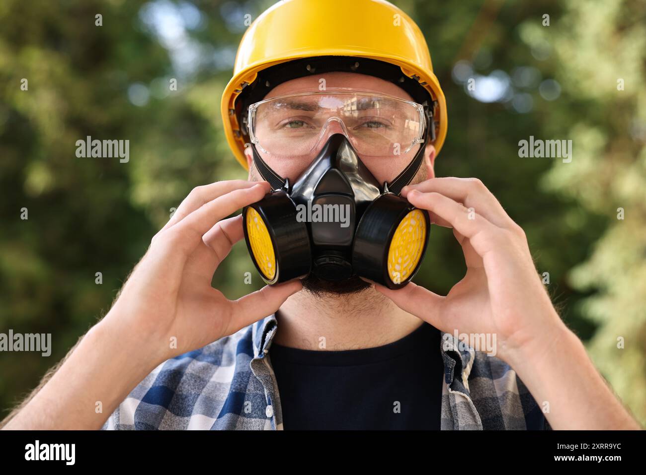 Man in respirator mask and hard hat outdoors. Safety equipment Stock ...
