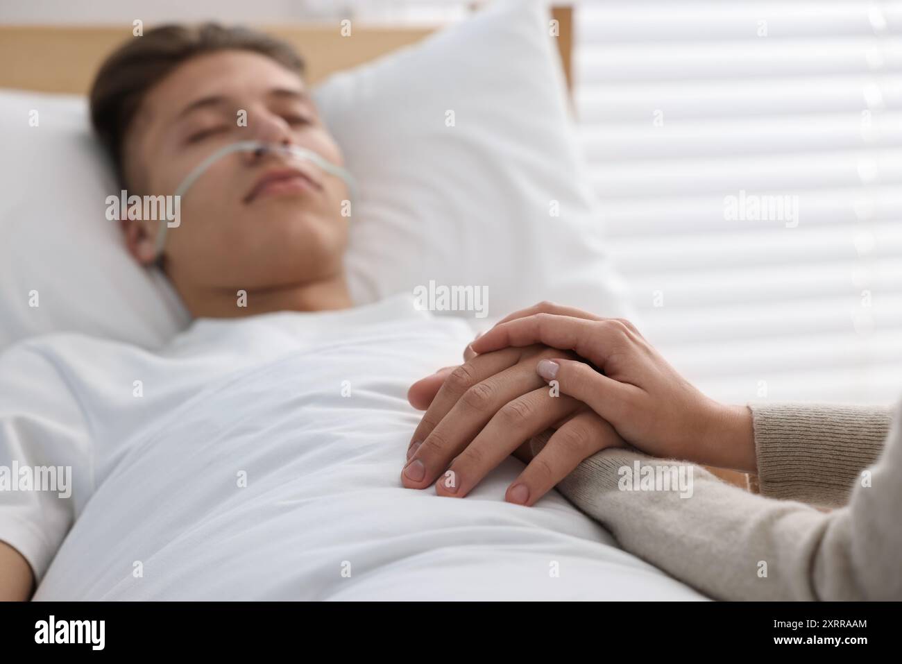 Coma patient. Woman near her husband in hospital, selective focus Stock ...