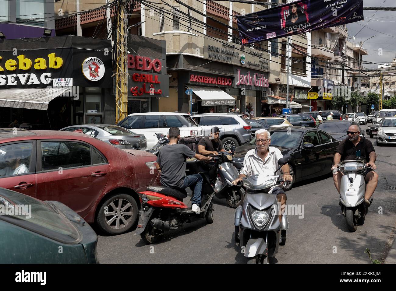 Beirut, Lebanon. 10th Aug, 2024. Men ride scooters through the streets ...