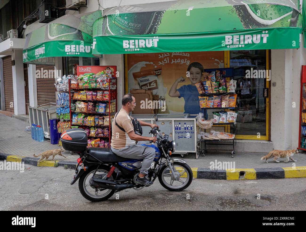 Beirut, Lebanon. 10th Aug, 2024. A man on a scooter rides through the ...