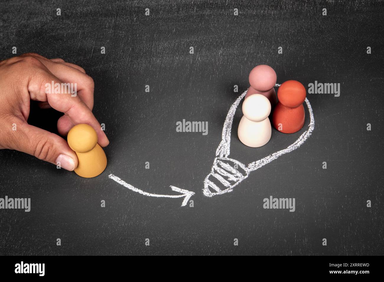 Creative ideas concept. Wooden human figures on a chalkboard background ...