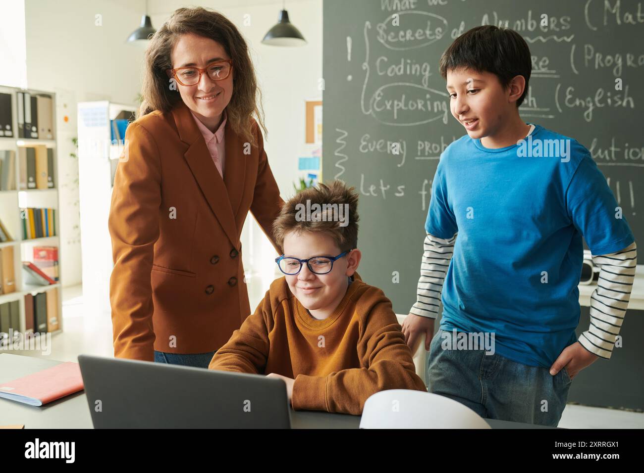 Smiling Female Teacher Two Boys Looking at Laptop Stock Photo - Alamy
